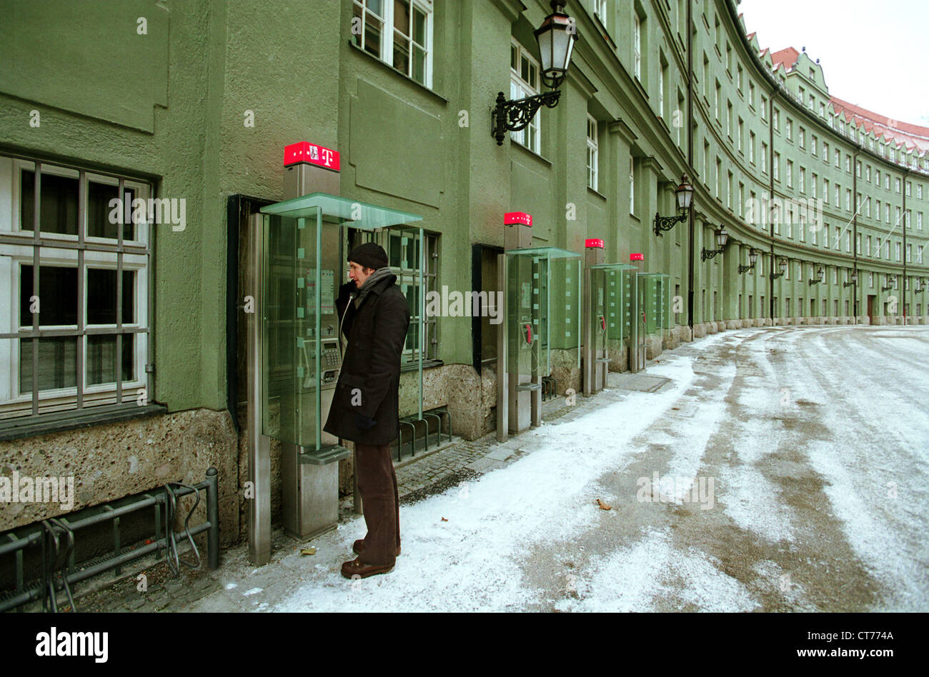 Man phoned public phone in winter Stock Photo - Alamy