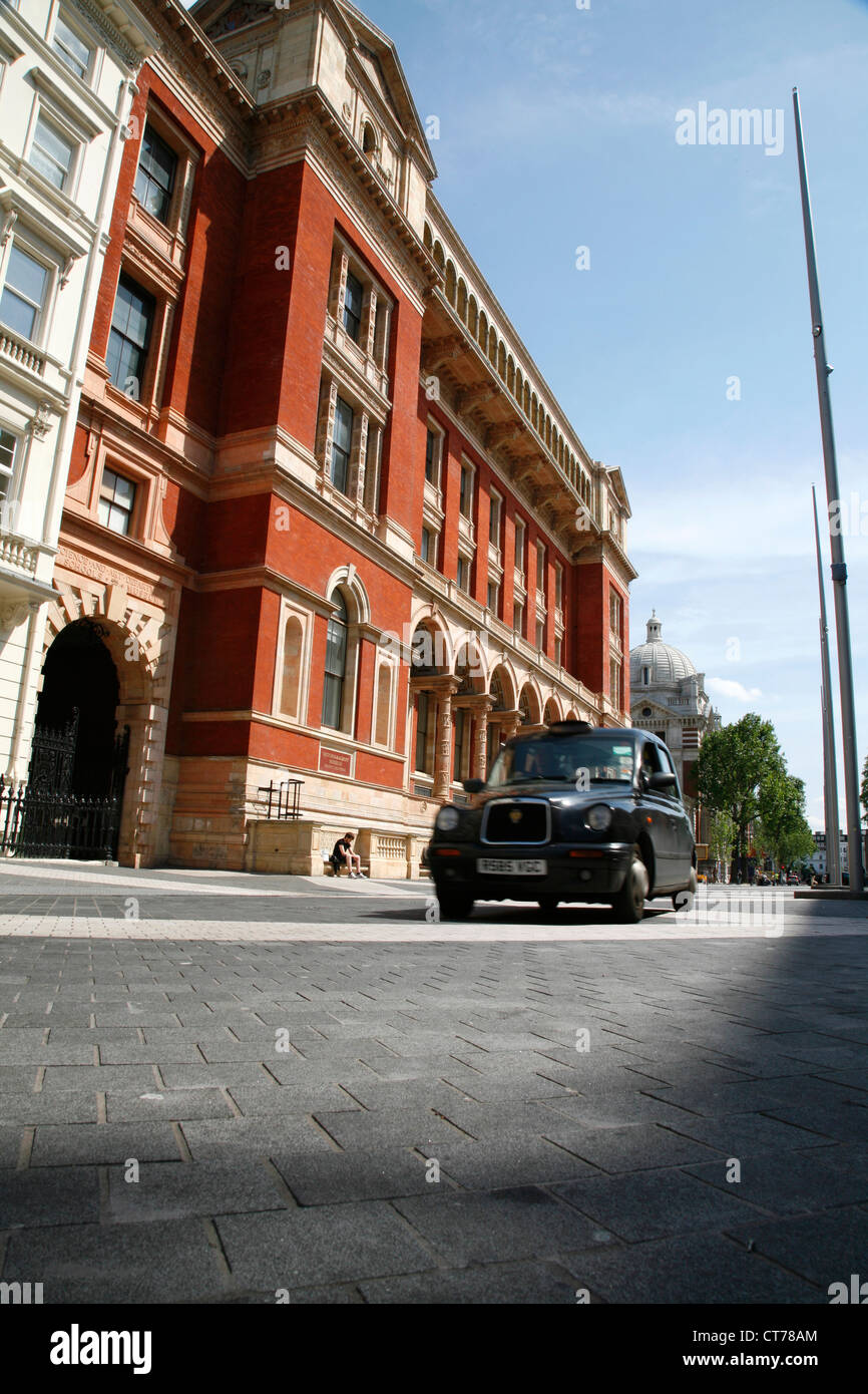 Taxi driving along Exhibition Road by the Henry Cole Wing of the ...