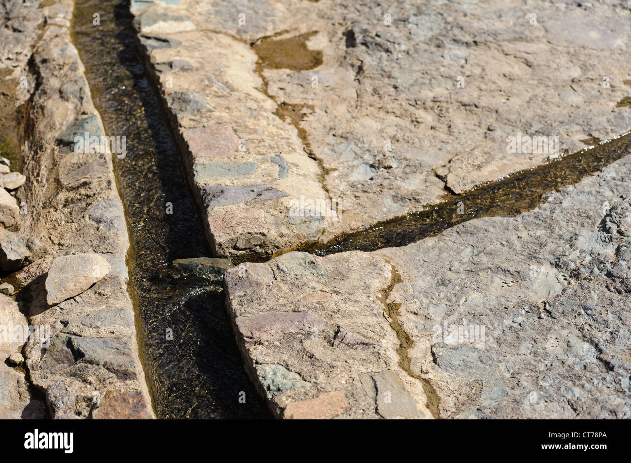 Water channels cut into the rock by the Inca, Ollantaytambo, Peru Stock ...
