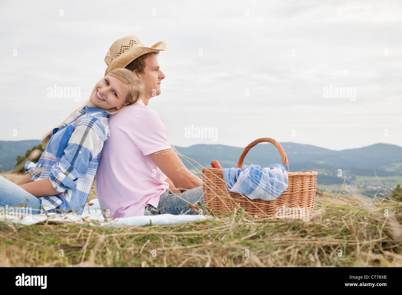 young couple having picnic in field Stock Photo - Alamy