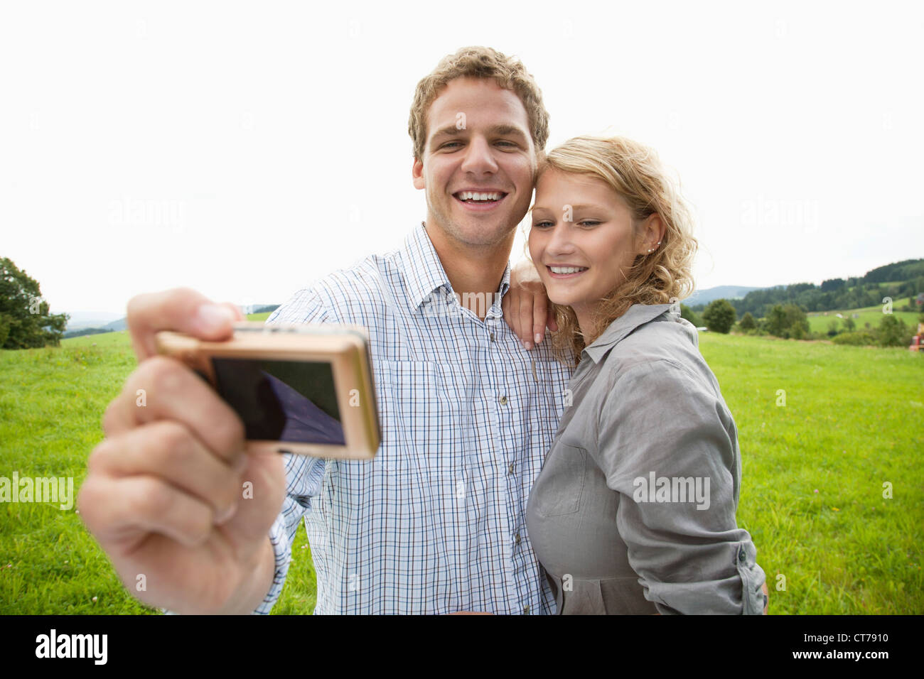 young couple taking self-portrait with digital camera Stock Photo - Alamy