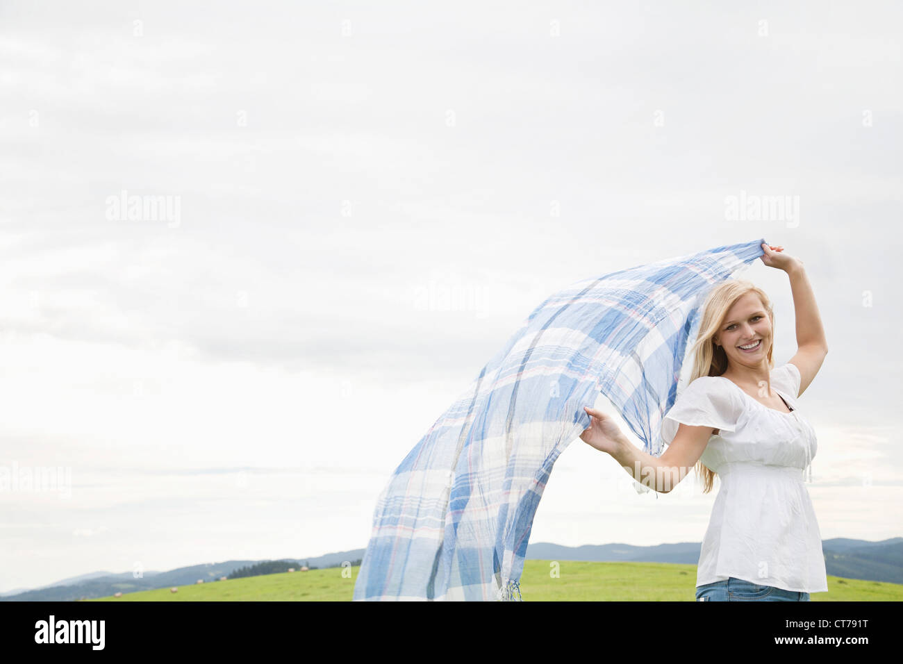 young woman waving cloth through the air Stock Photo - Alamy