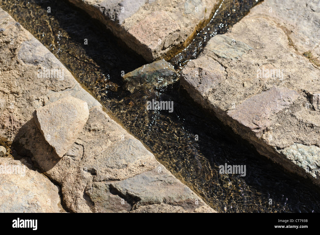Water channels cut into the rock by the Inca, Ollantaytambo, Peru Stock ...