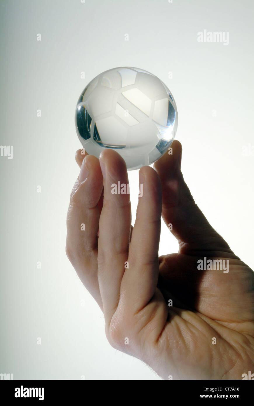 A hand with a small glass of Soccer Stock Photo - Alamy