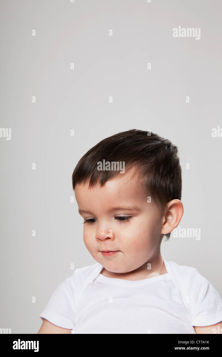 Baby boy looking down Stock Photo - Alamy