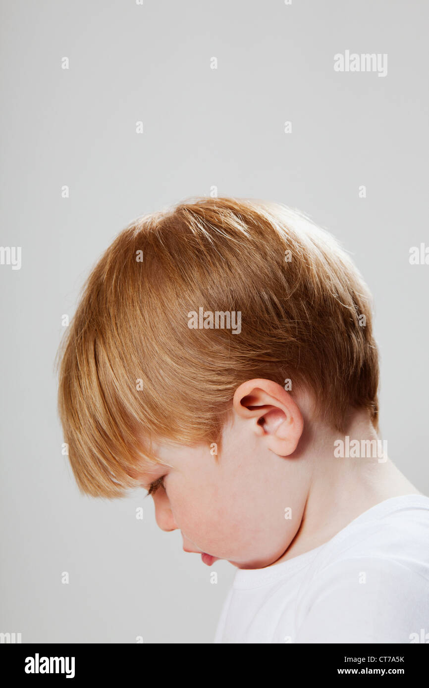 Boy looking down Stock Photo - Alamy