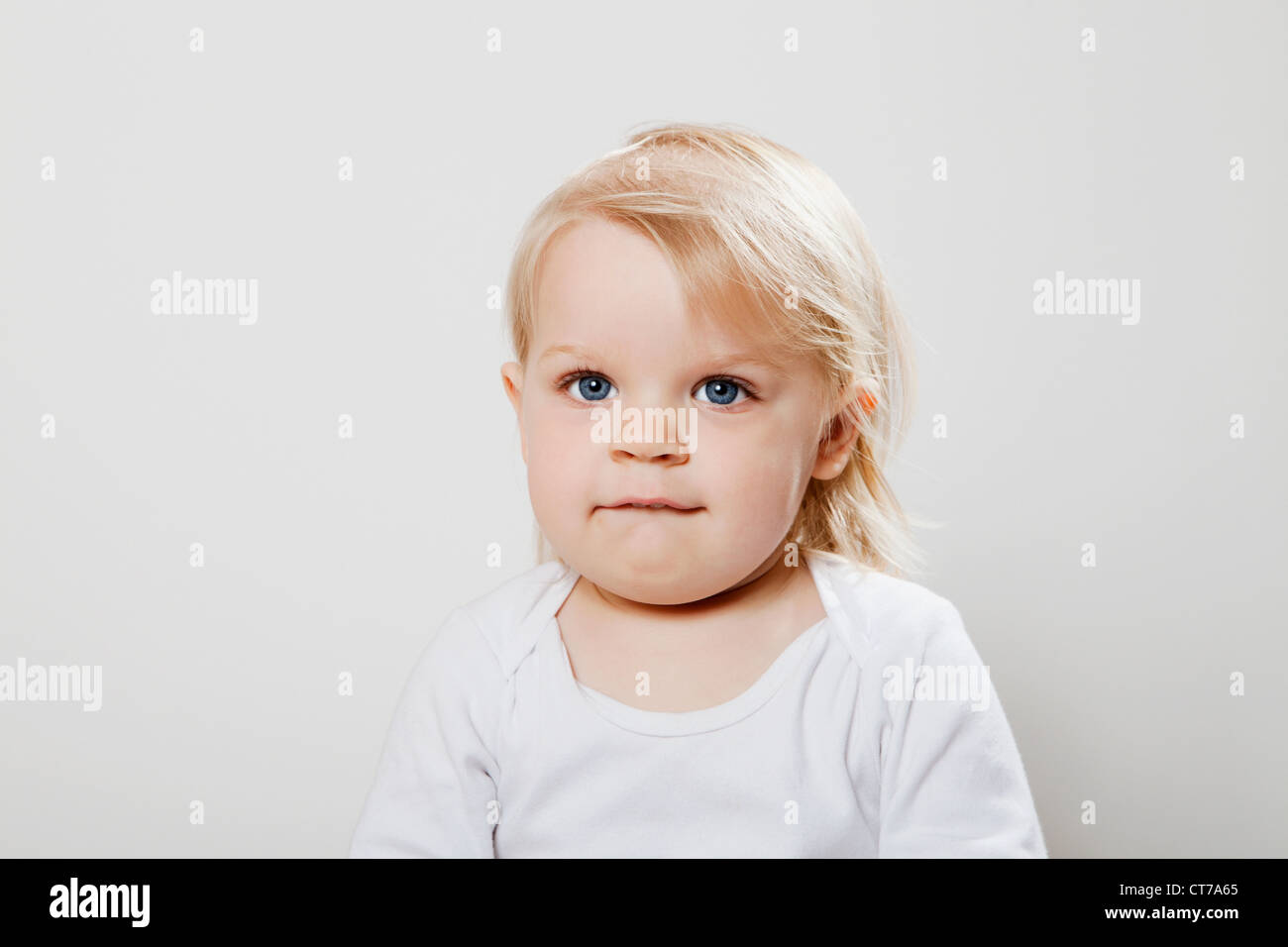 Girl biting lip Stock Photo - Alamy
