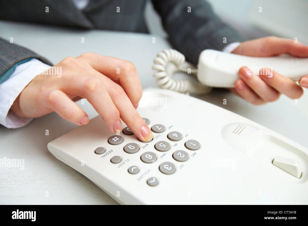 Female hand holding phone receiver and dialing number Stock Photo - Alamy