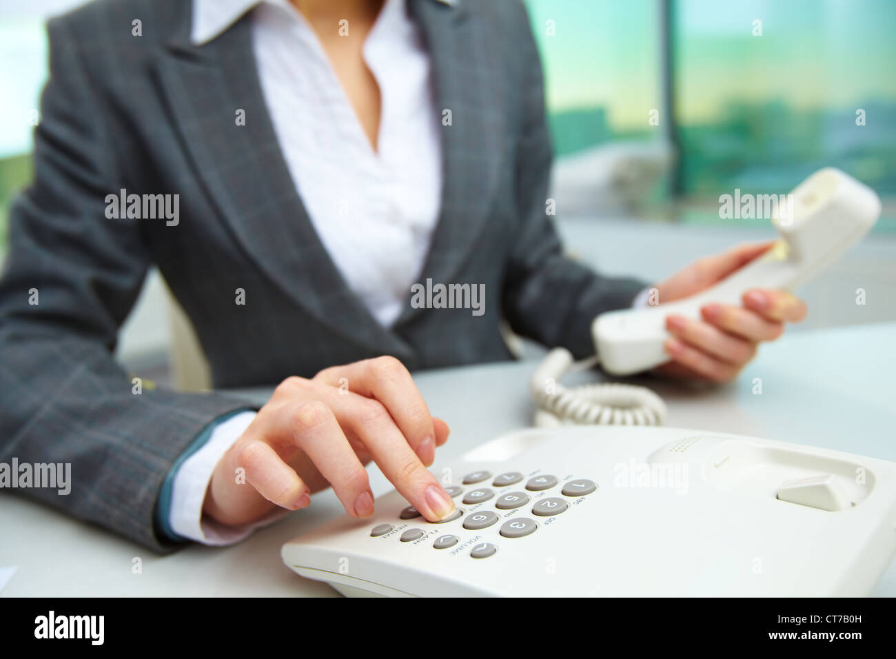 Female hand dialing number in office Stock Photo - Alamy