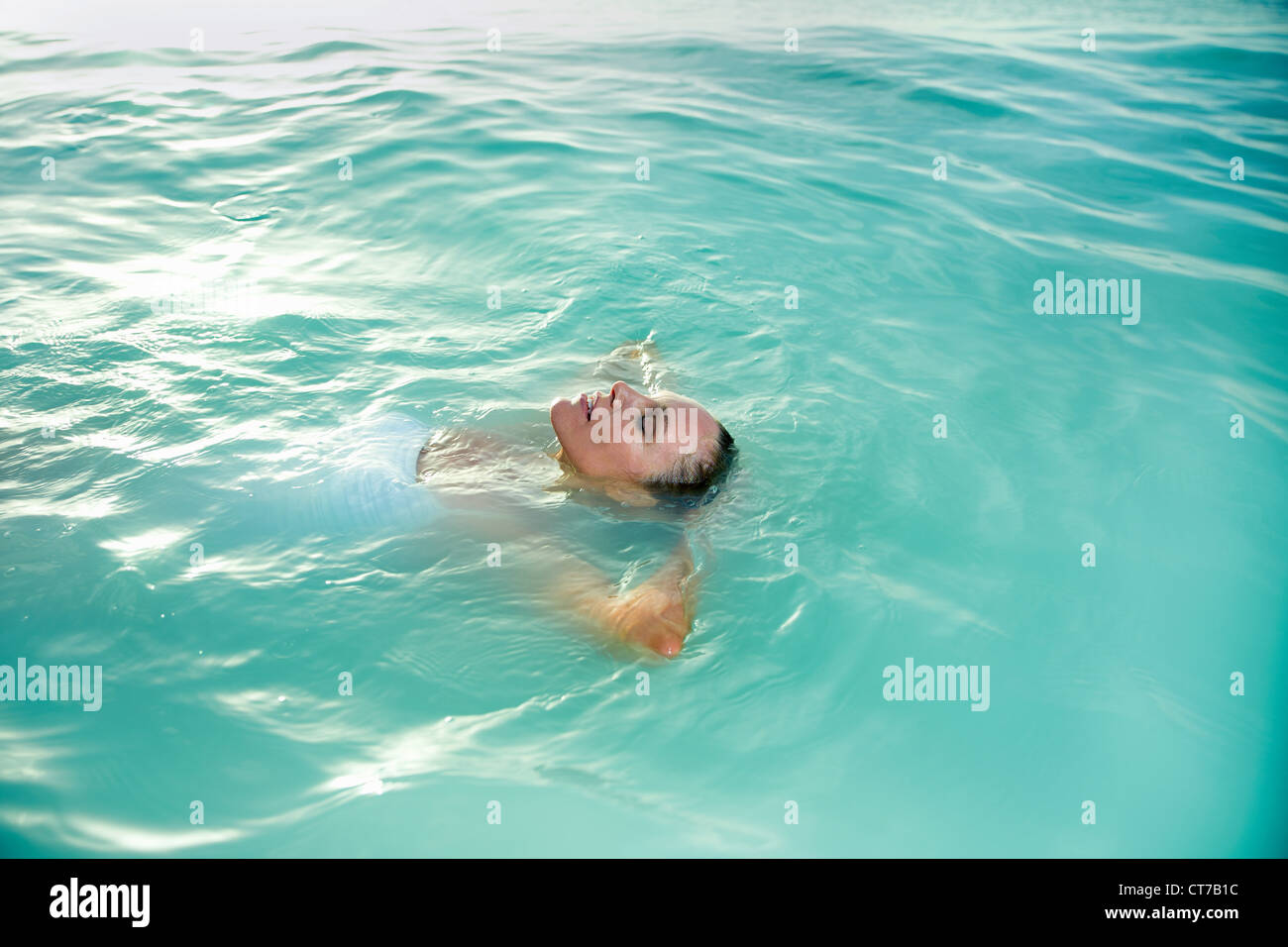 Relaxed woman floating in ocean Stock Photo - Alamy