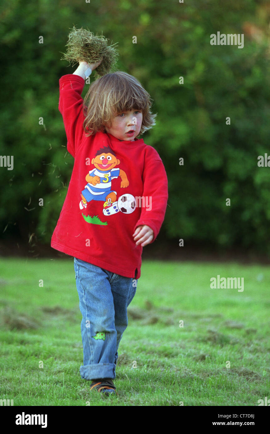 A child throws with Grass Stock Photo - Alamy