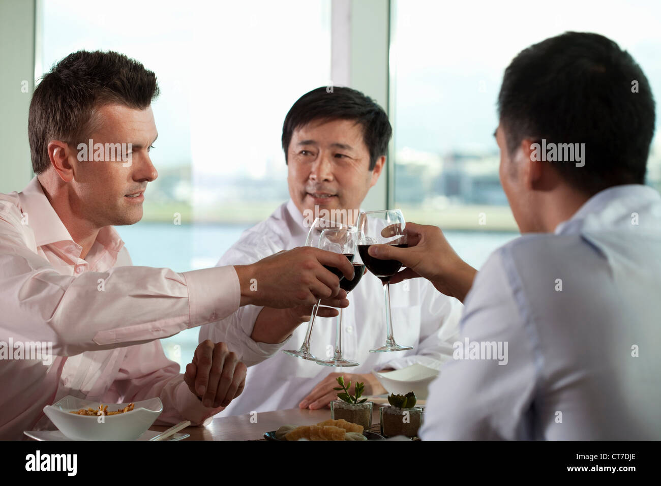 Three business people toasting their success Stock Photo - Alamy