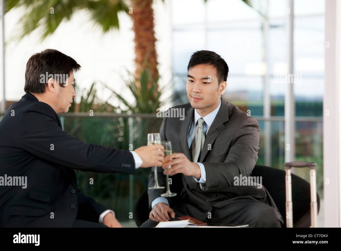 Businessmen toasting with wine Stock Photo - Alamy