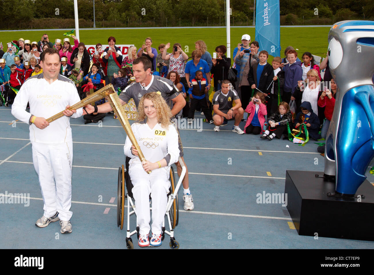 Gemma Collis (R) passes the Olympic Torch to Ian Estick (L) in Stoke ...