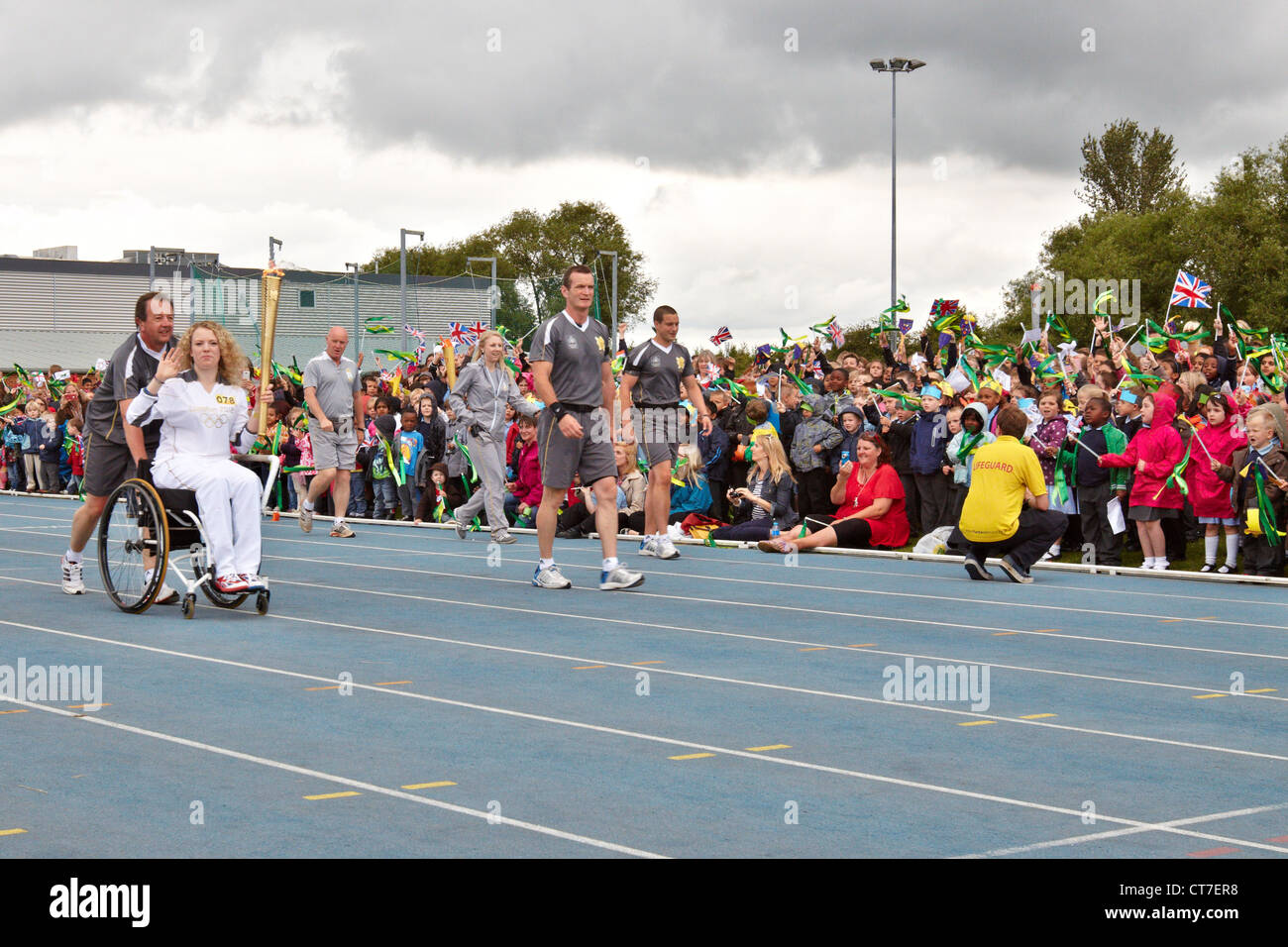 Gemma Collis enters Stoke Mandeville Stadium carrying the Olympic Torch ...