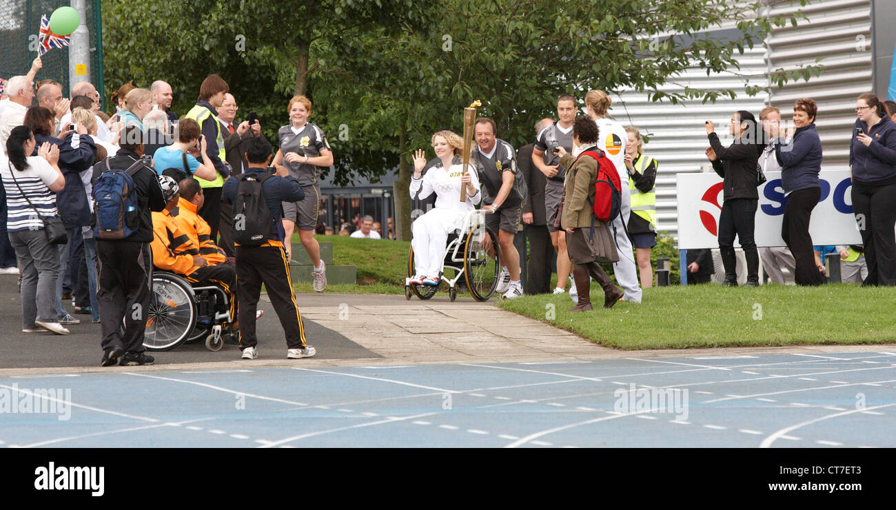 Gemma Collis enters Stoke Mandeville Stadium carrying the Olympic Torch ...