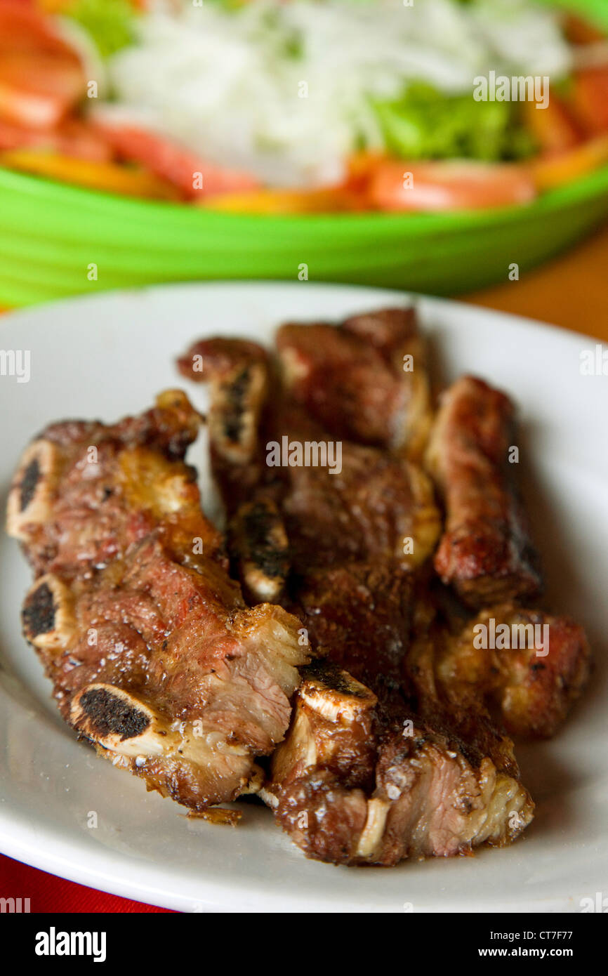 Beef cooked on an asado in a steak house Stock Photo - Alamy