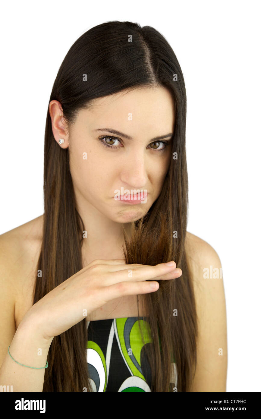 Young female model making funny face because of her split ends hair ...