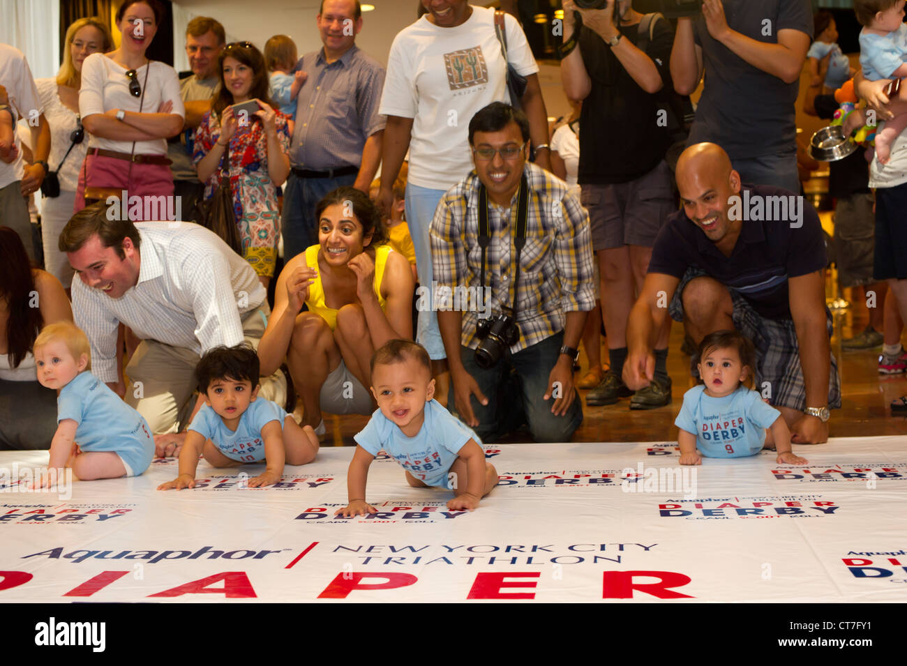 Babies crawl to the finish line in a Diaper Derby in New York Stock ...