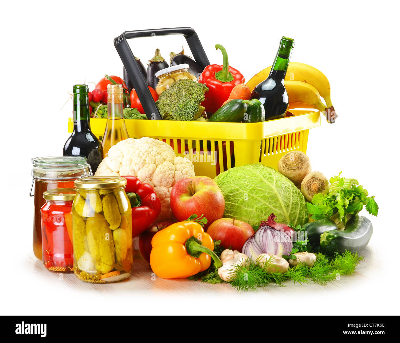 Composition with plastic shopping basket and grocery isolated on white ...