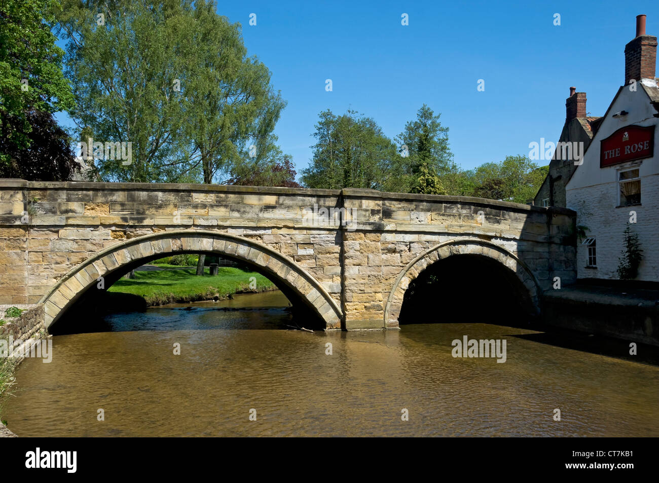 Traditional stone bridge across Pickering Beck in summer Pickering ...