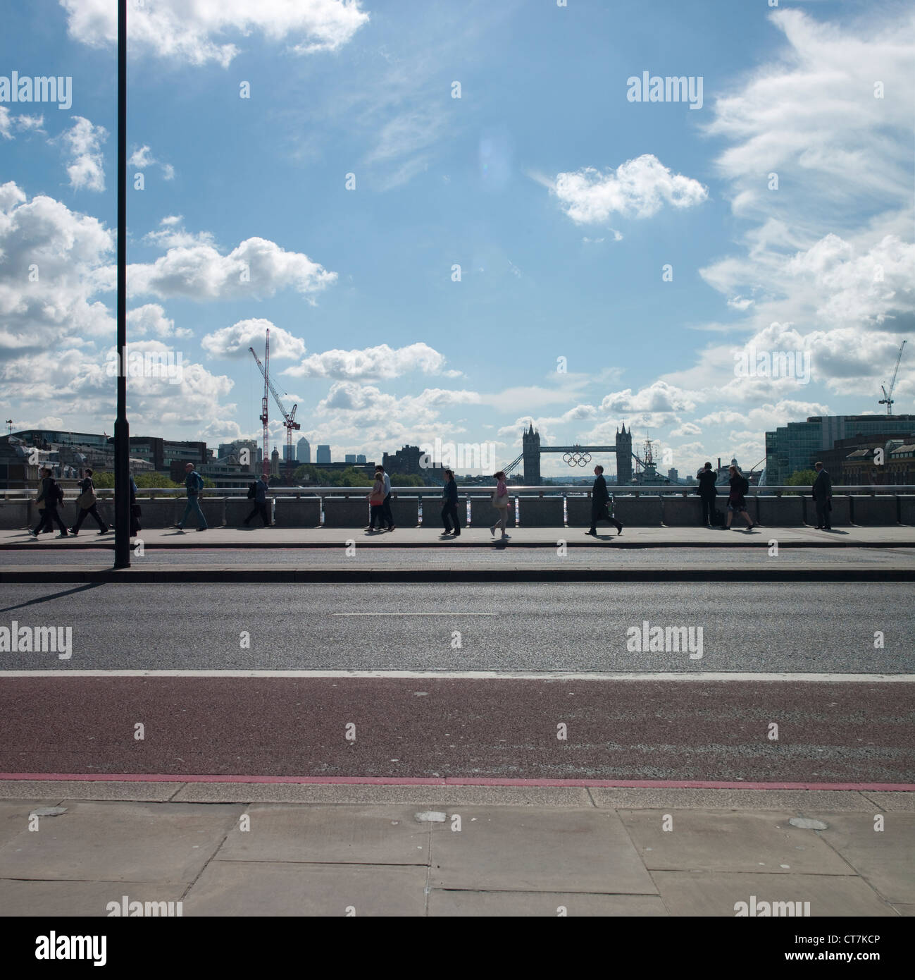 Pedestrians crossing London Bridge with the Olympic Games symbol on ...