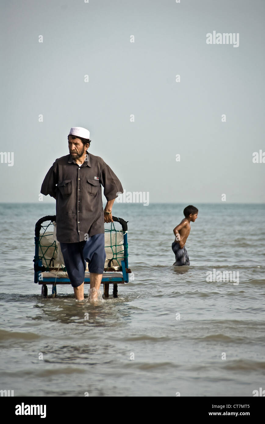 Man collecting goods in the Persian gulf, Bandar-e Abbas. Iran Stock ...