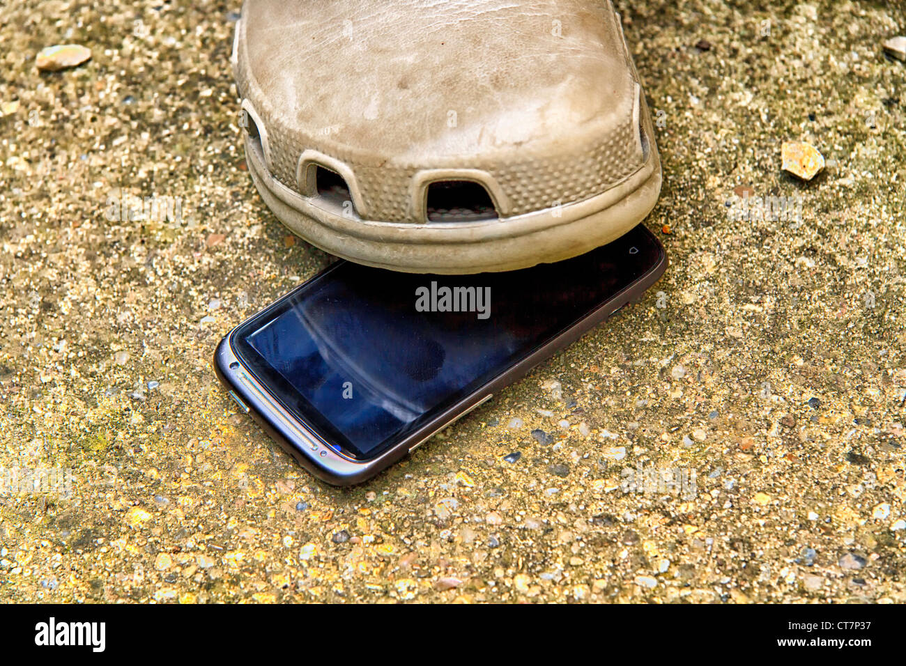 Foot about to crush a smartphone on a pavement Stock Photo - Alamy
