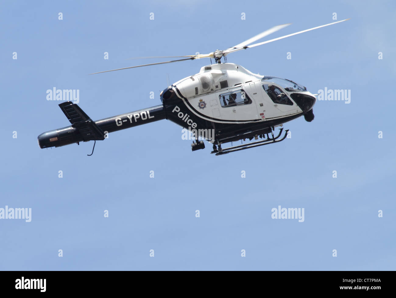 police helicopter in flight against a pale blue sky Stock Photo - Alamy
