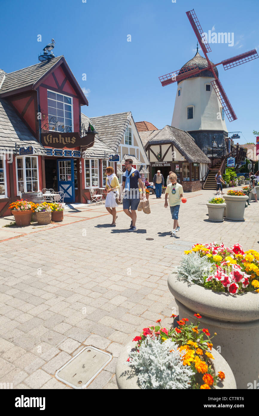 tourists walking among windmill and shops in Danish town of Solvang ...