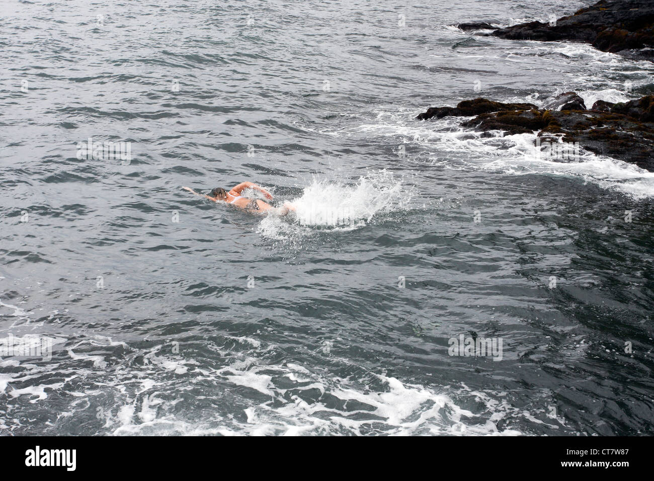 Young woman swimming in the bay Stock Photo - Alamy