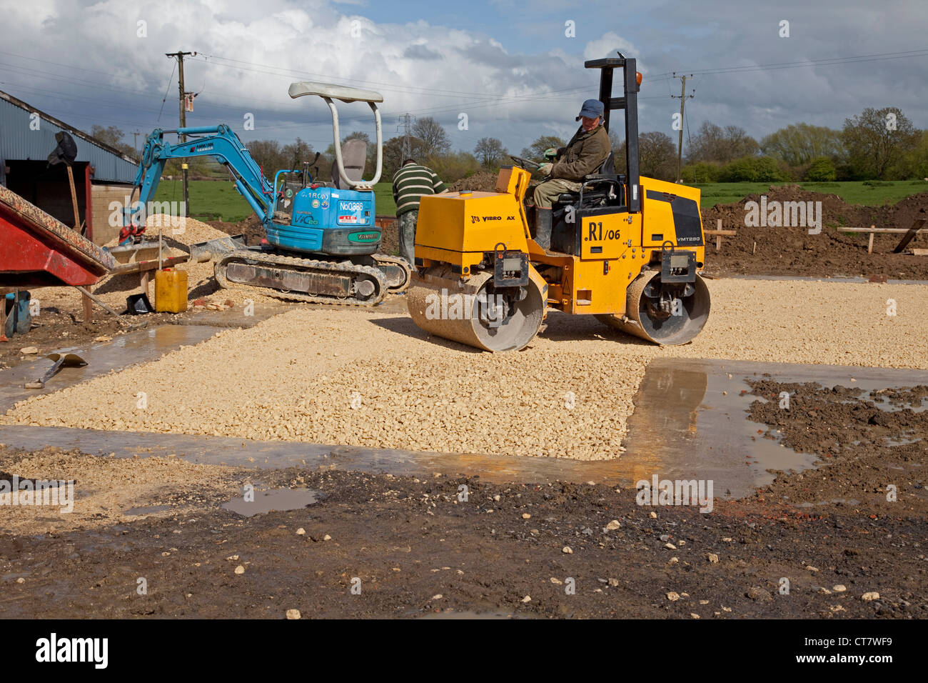 Builder on JCB compactor preparing foundations Colemans Hill Farm ...