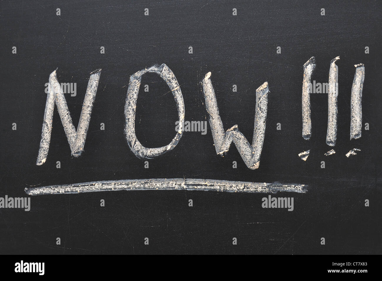 word Now handwritten on black chalkboard Stock Photo - Alamy