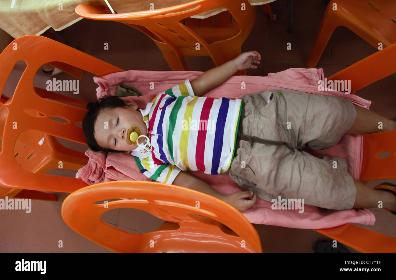 It's a photo of a 2 years old baby Chinese boy who is having a nap on 2 ...