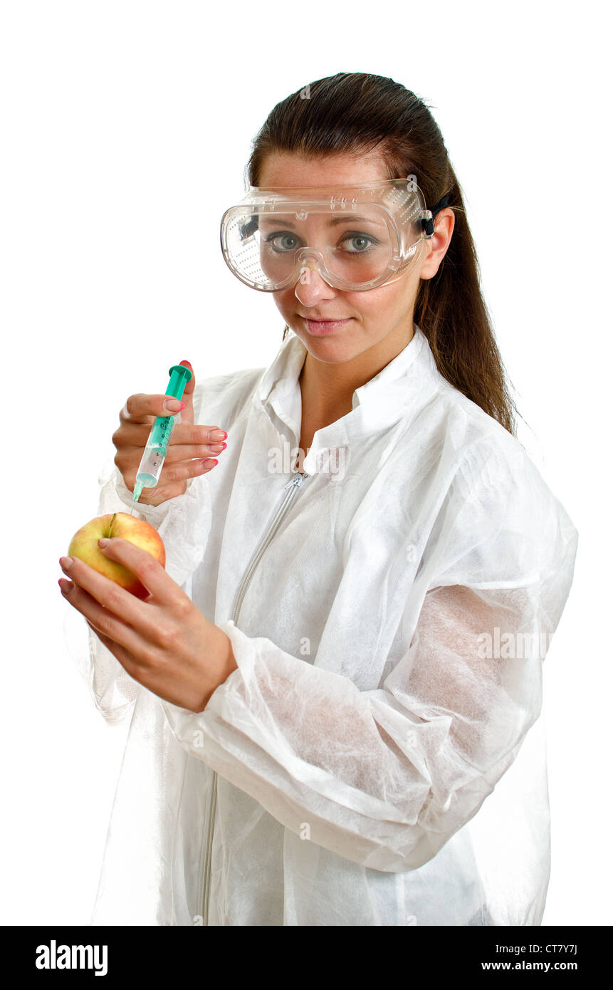 Female scientist in lab coat with syringe and apple. Isolated on white ...