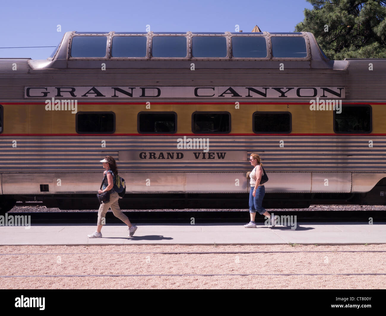 Two passengers walking past the observation coach of the Grand Canyon ...
