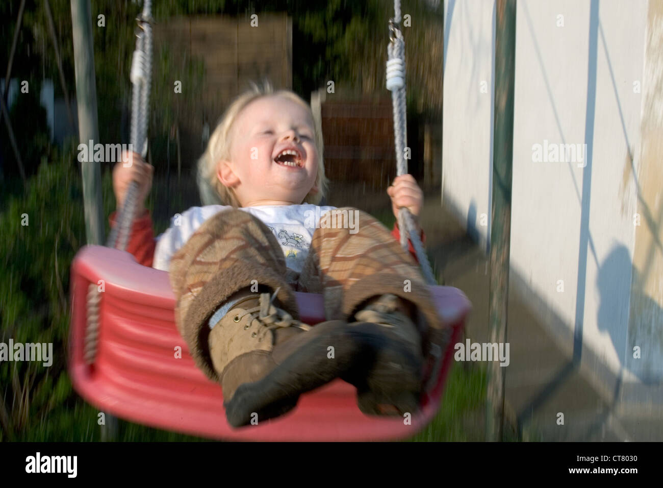 Berlin, rocking a child Stock Photo - Alamy