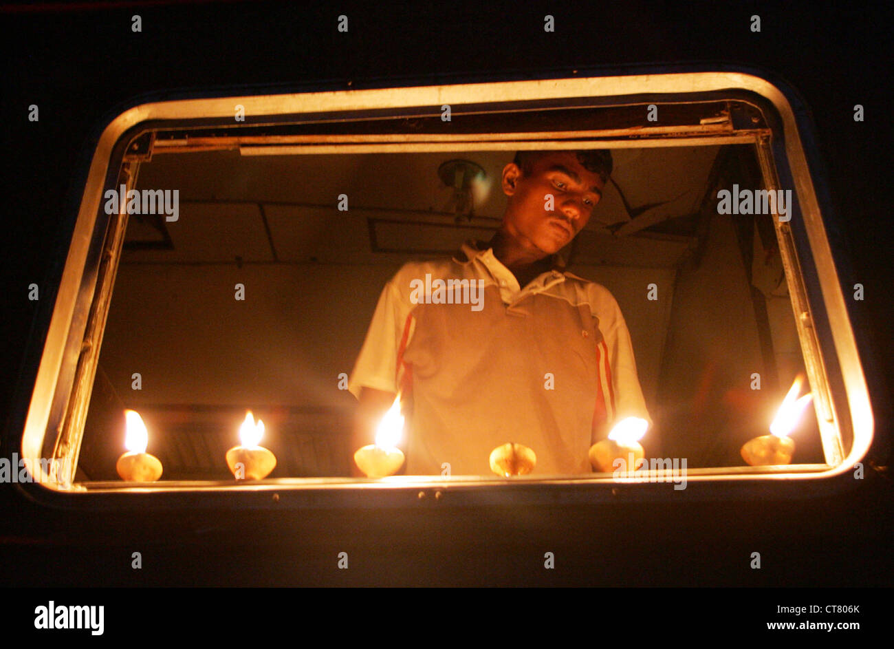 Igniting candles in a train-wreck, Thelwatta Stock Photo - Alamy