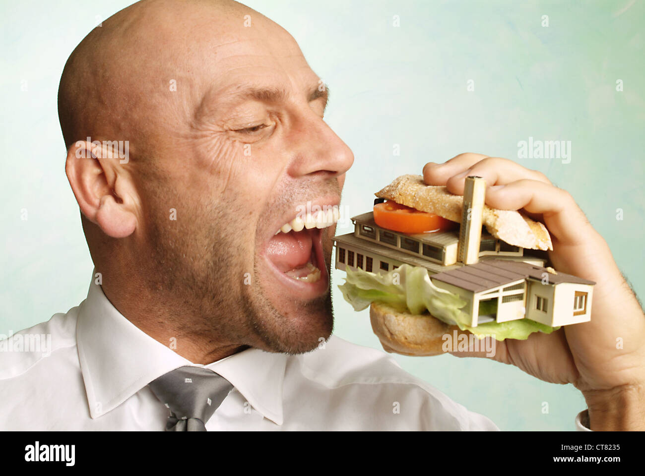 Man biting into a sandwich factory Stock Photo - Alamy