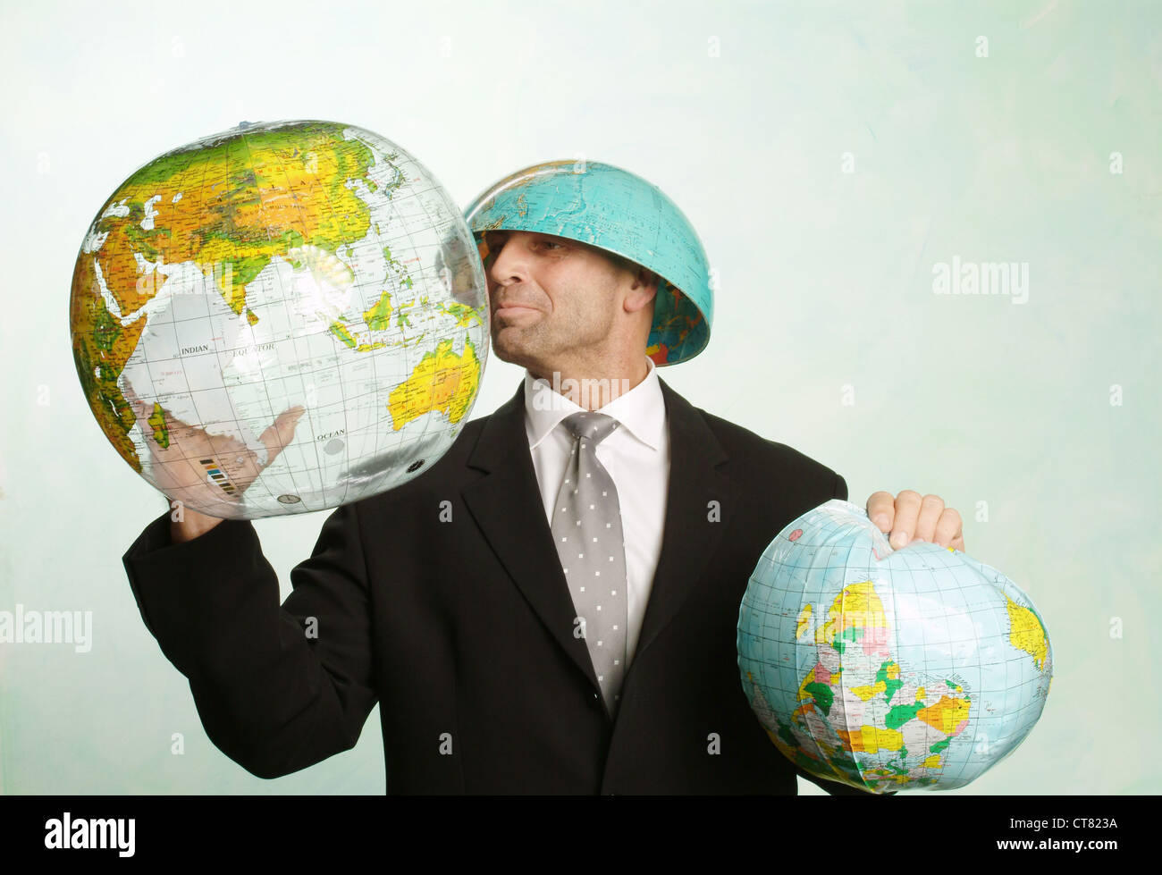 Man with globes Stock Photo - Alamy