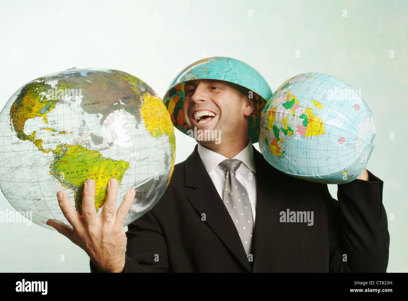 Man with globes Stock Photo - Alamy