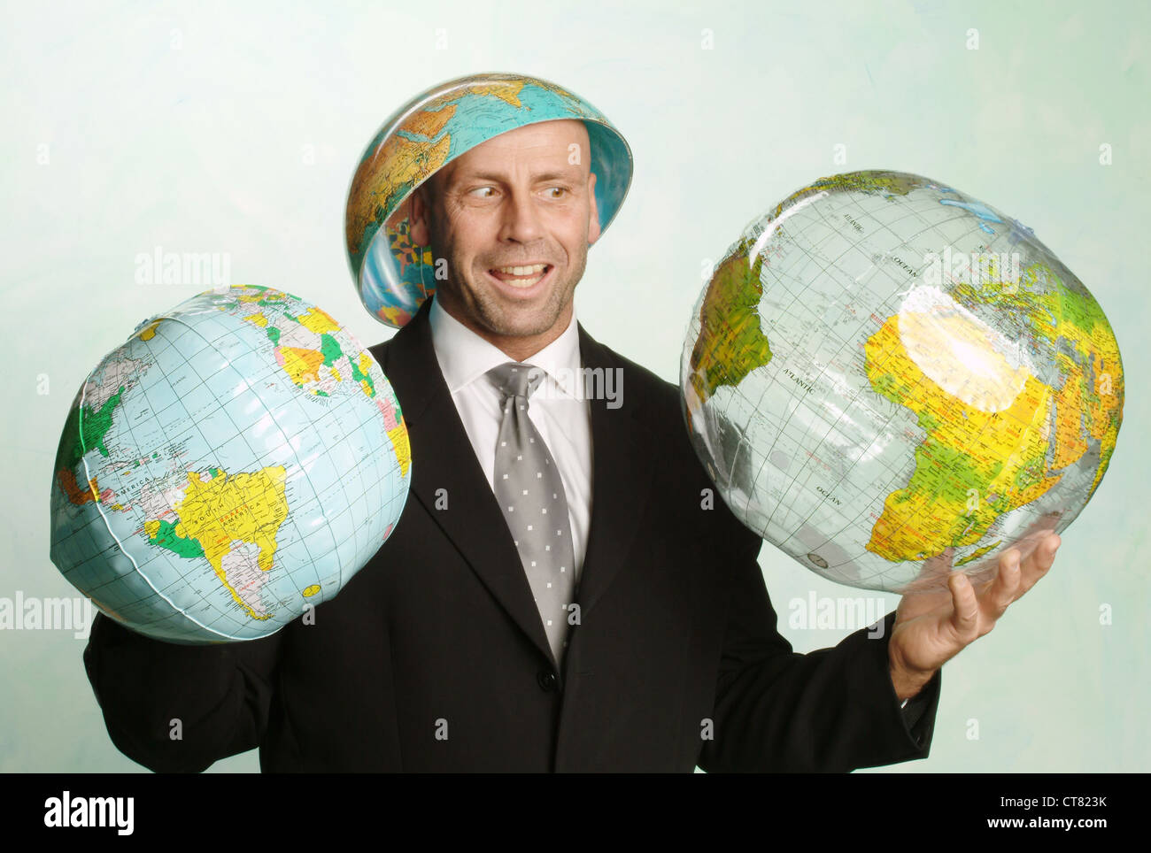 Man with globes Stock Photo - Alamy