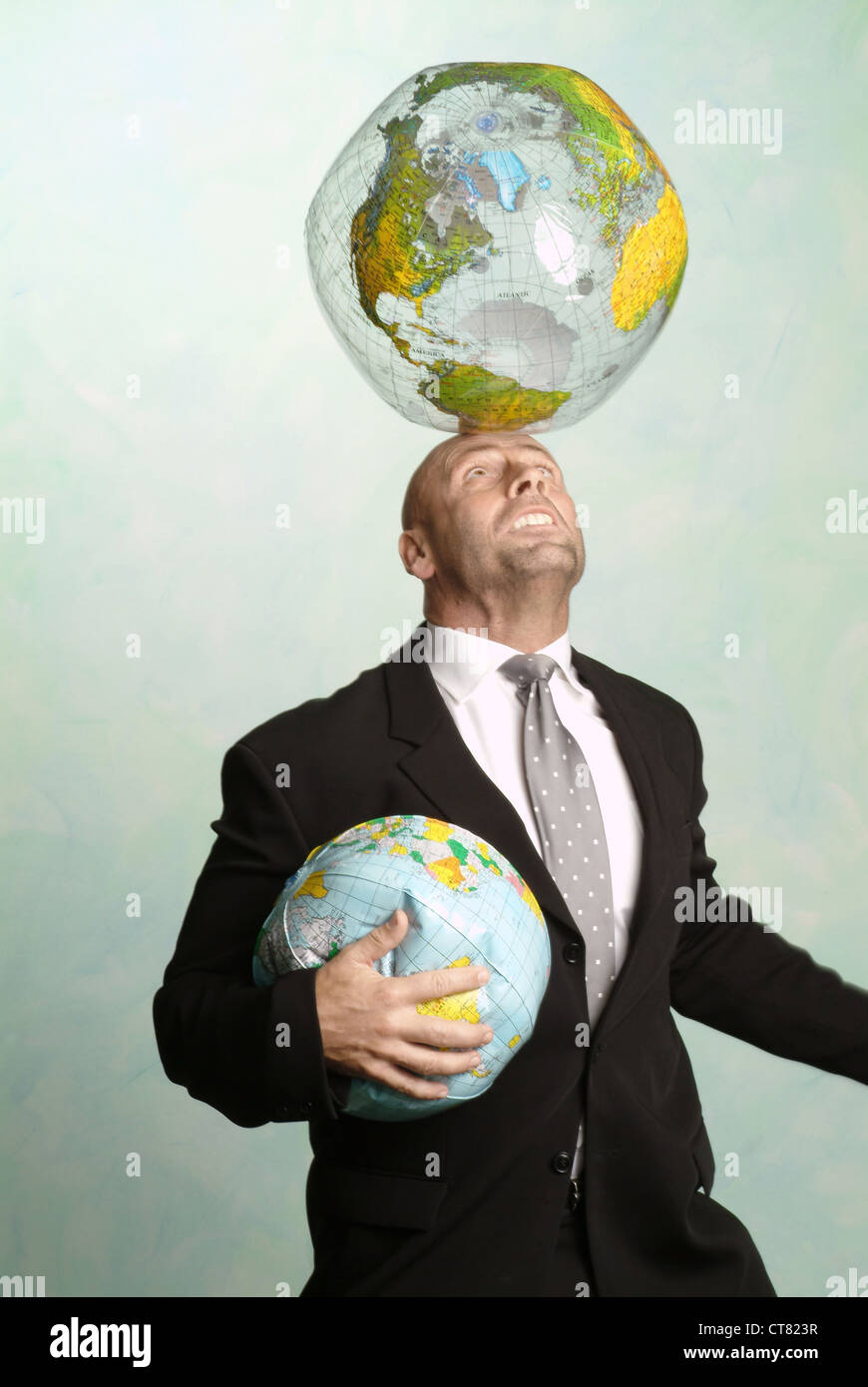 Man juggling with globes Stock Photo - Alamy