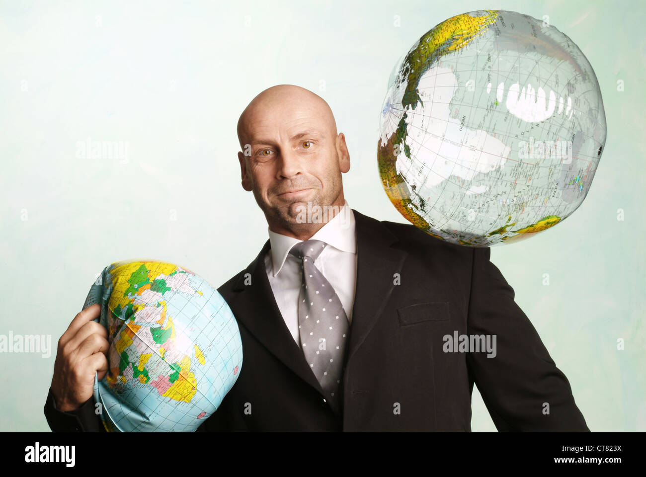 Man posing with globes Stock Photo - Alamy