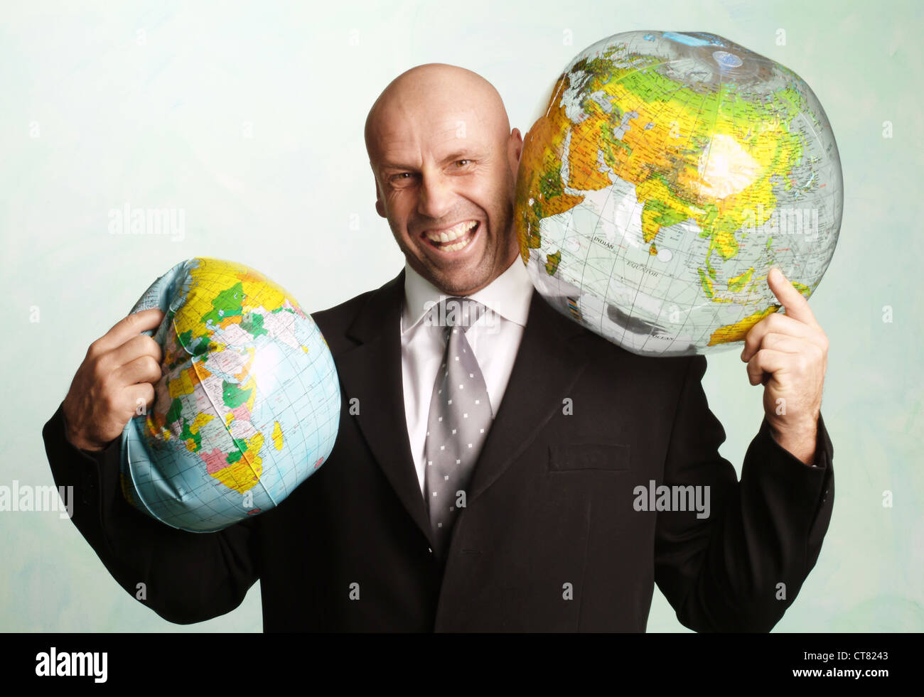 Man posing with globes Stock Photo - Alamy