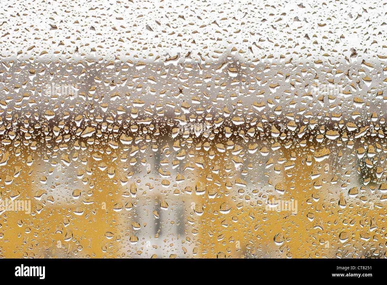 Rain Drop Pattern on a Window with Blurry Building Stock Photo - Alamy