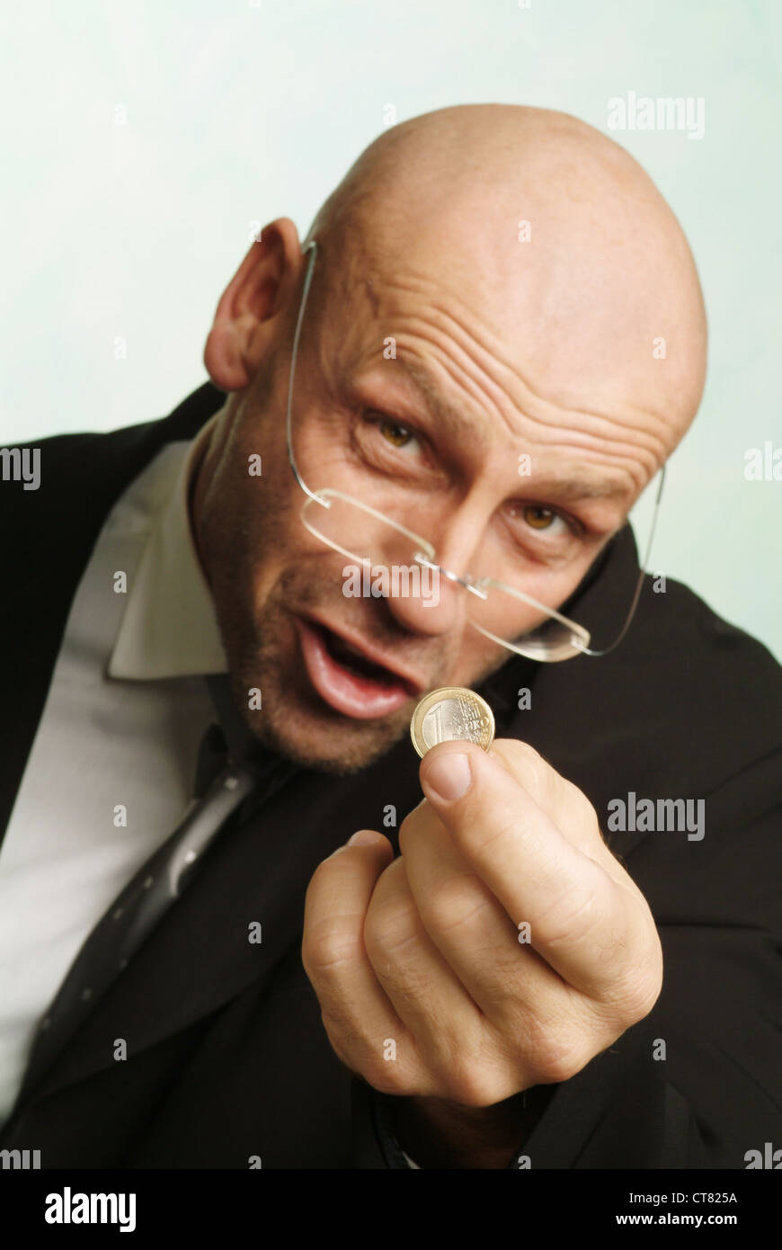Man with 1-euro piece in hand Stock Photo - Alamy