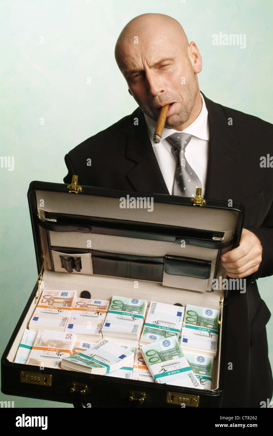 Man posing with cigar and money box Stock Photo - Alamy