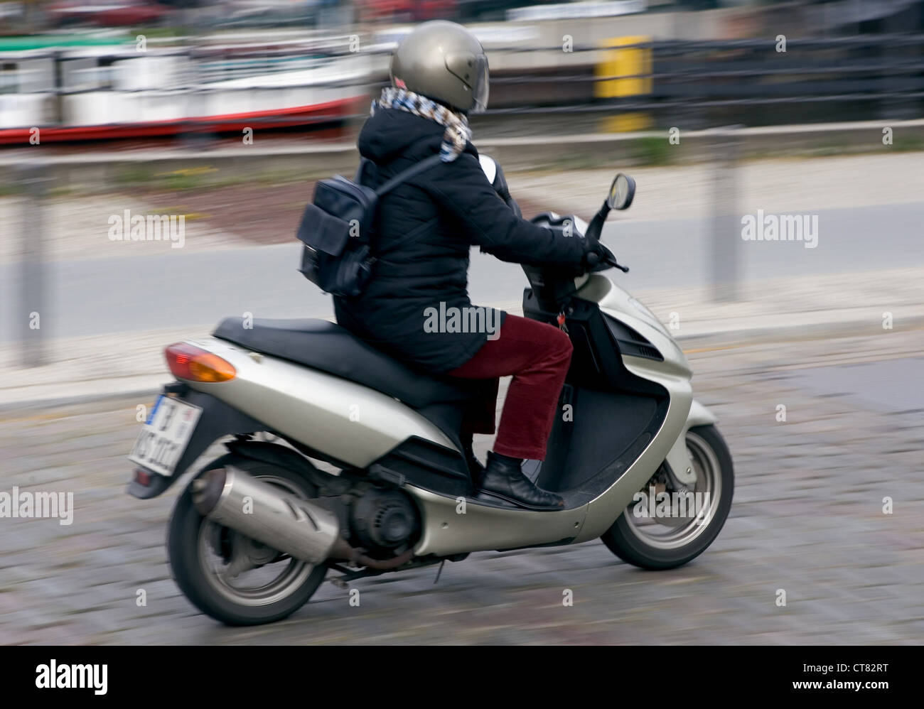Scooter driver in traffic Stock Photo - Alamy