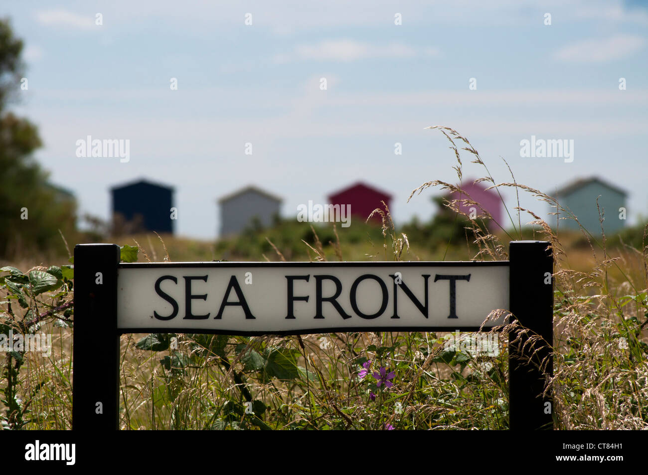 Sea Front street sign with beach huts in the background, SSSI meadow ...